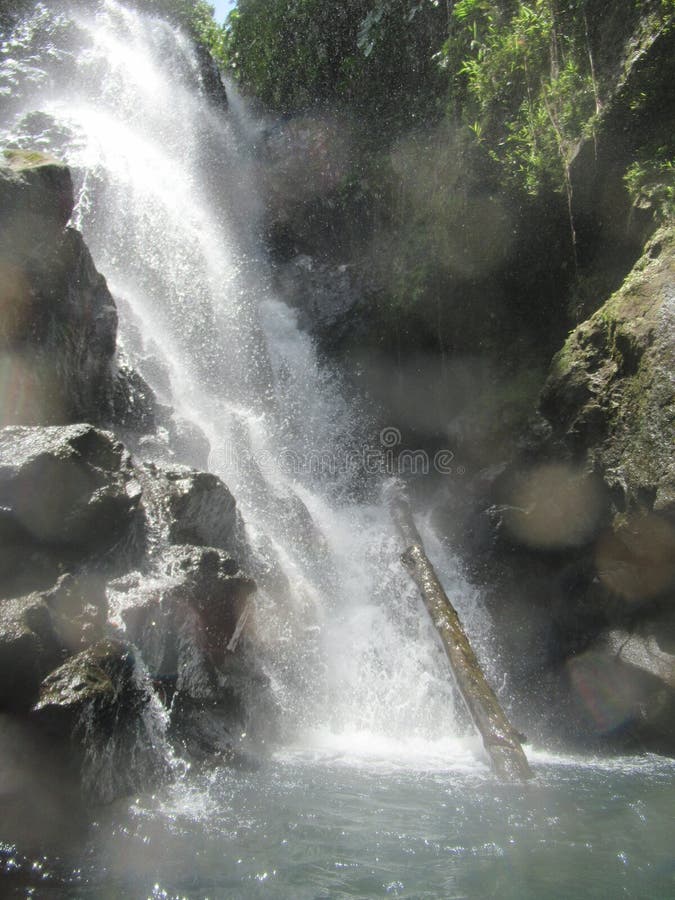 A Powerful Waterfall Falls between the Rocks Stock Image - Image of ...