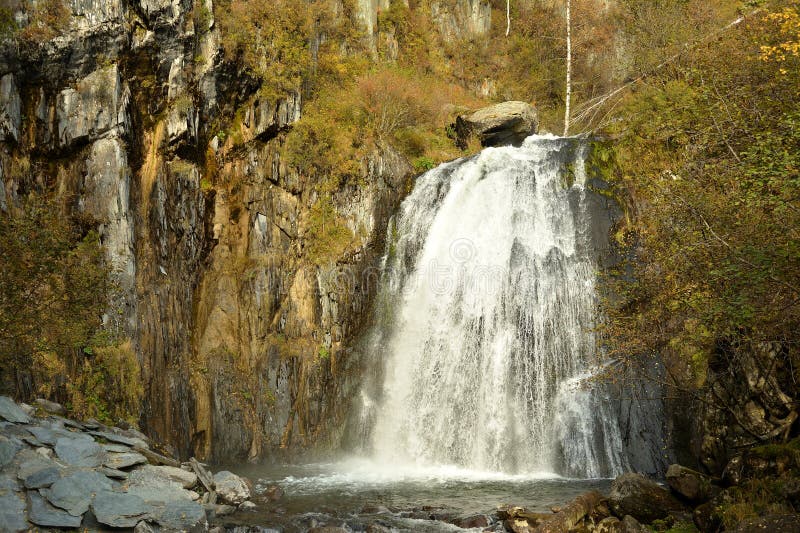 A Powerful Waterfall Flows in a Wide Stream from a High Mountain ...