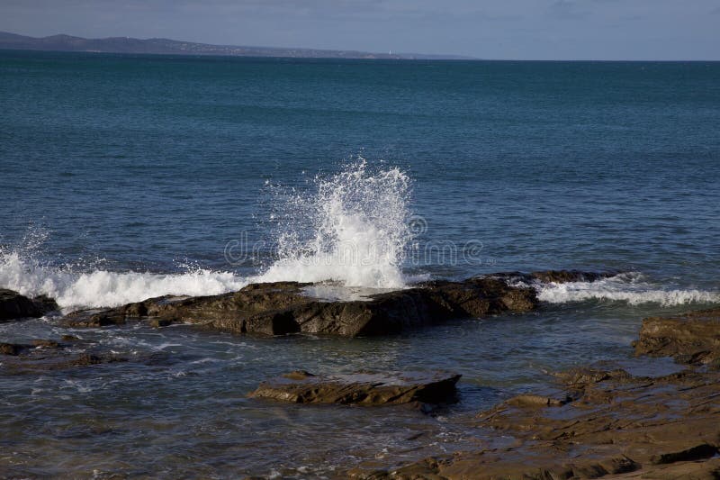 Powerful Wave Crashes Against a Rocky Shoreline, Creating an Impressive ...