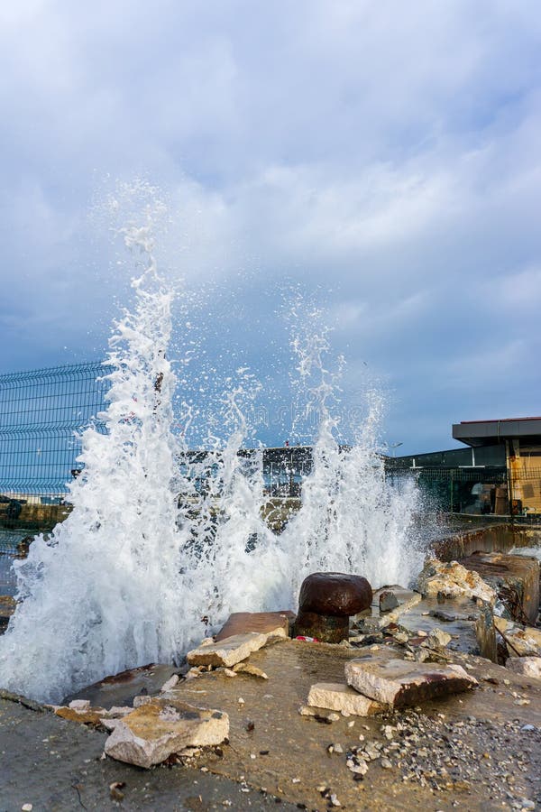 Crashing Waves on a Weathered Pier. White Waves Breaking on a Rocky ...