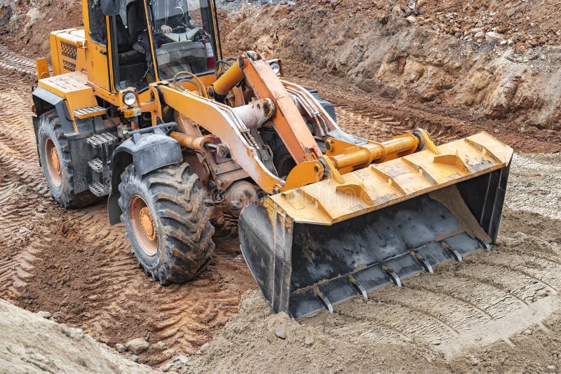 Powerful Wheel Loader or Bulldozer Working on a Quarry or Construction ...