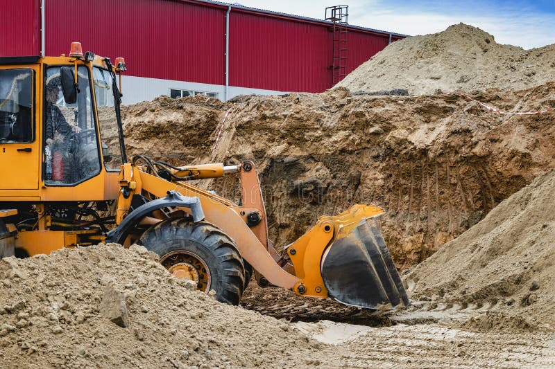 Powerful Wheel Loader or Bulldozer Working on a Quarry or Construction ...