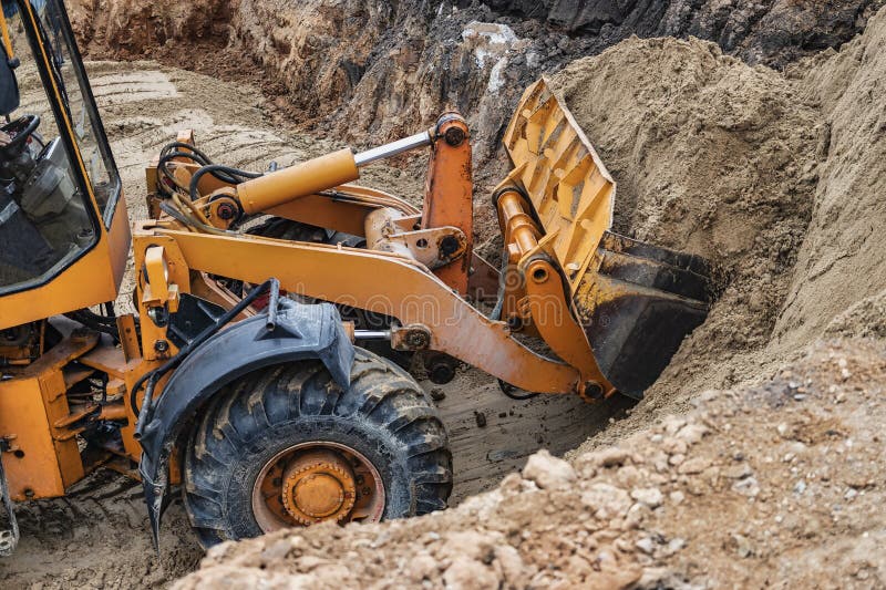 Powerful Wheel Loader or Bulldozer Working on a Quarry or Construction ...