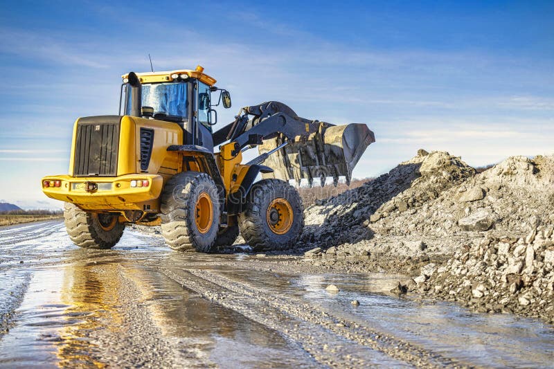 Powerful Wheel Loader or Bulldozer Working on a Quarry or Construction ...