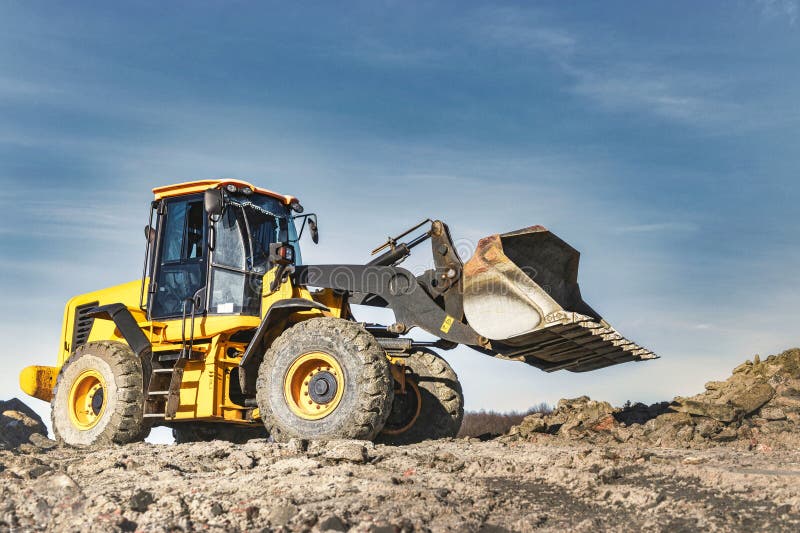 Powerful Wheel Loader or Bulldozer Working on a Quarry or Construction ...