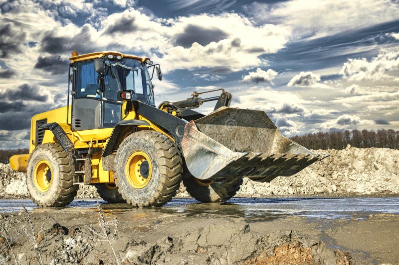 Powerful Wheel Loader or Bulldozer Working on a Quarry or Construction ...