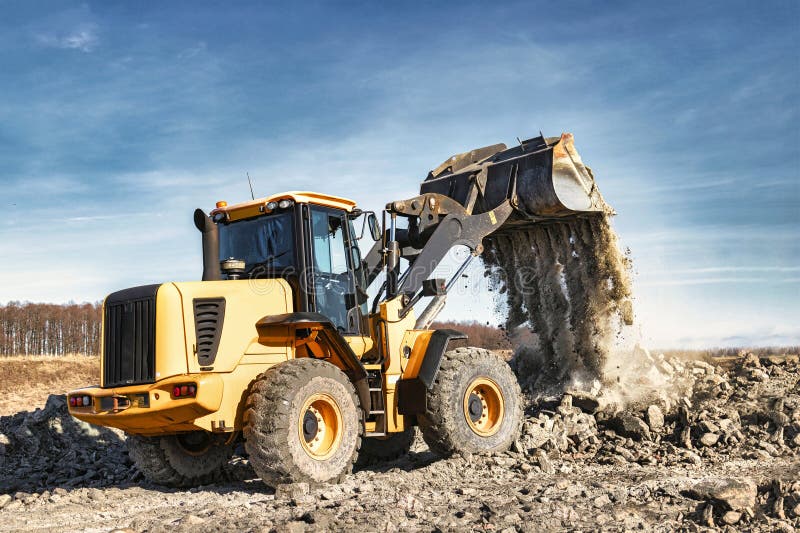 Powerful Wheel Loader or Bulldozer Working on a Quarry or Construction ...