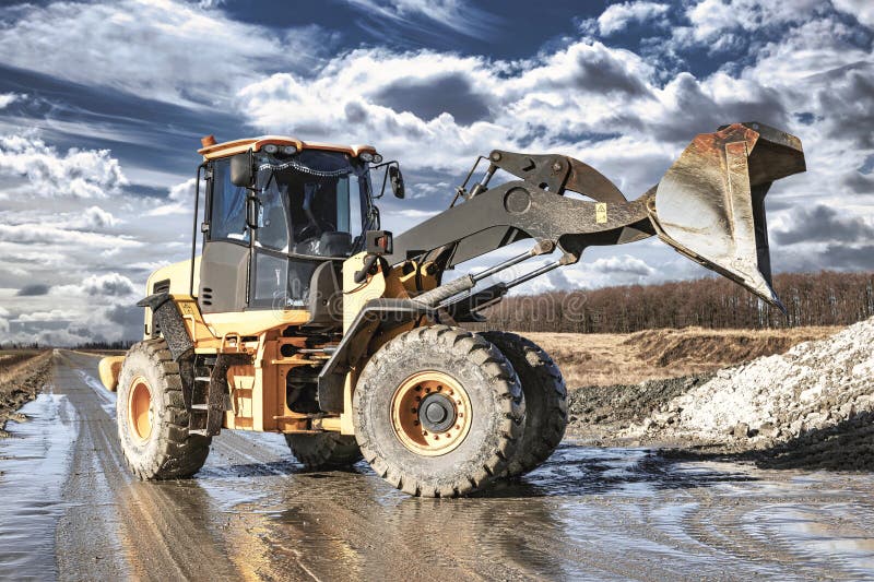 Powerful Wheel Loader or Bulldozer Working on a Quarry or Construction ...