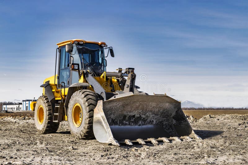Powerful Wheel Loader or Bulldozer Working on a Quarry or Construction ...