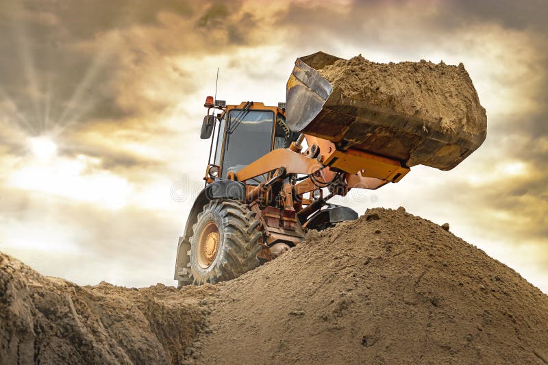Powerful Wheel Loader or Bulldozer Working on a Quarry or Construction ...