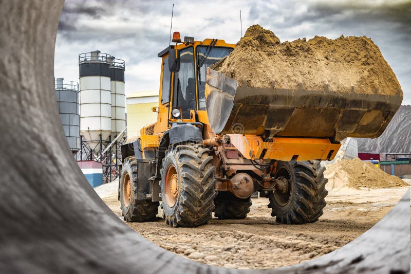 Powerful Wheel Loader or Bulldozer Working on a Quarry or Construction ...