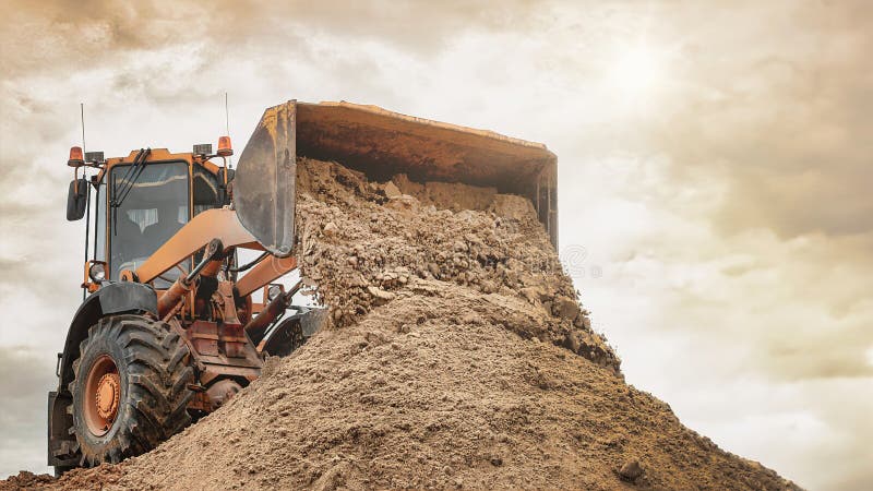 Powerful Wheel Loader or Bulldozer Working on a Quarry or Construction ...