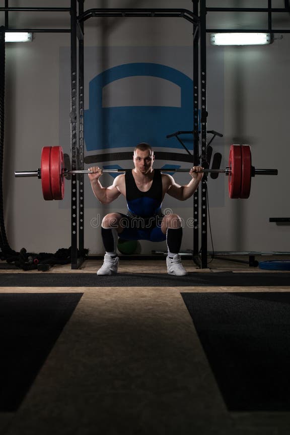 Powerlifter Using Barbell Exercising Legs Inside Gym Stock Photo ...