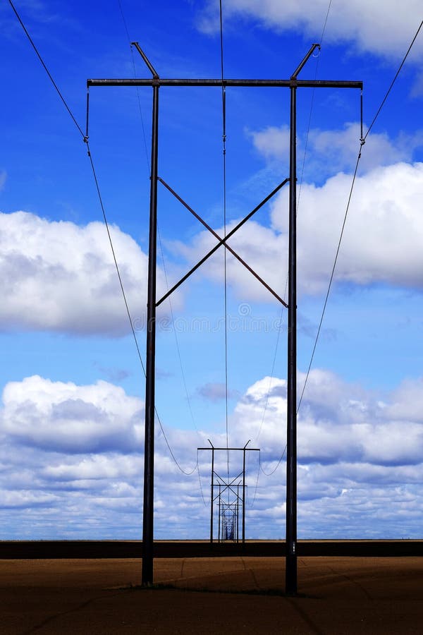Powerlines in Field with Blue Sky and Clouds Reflection in Water Stock ...