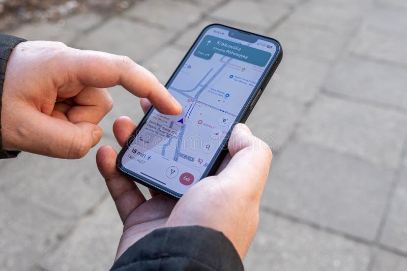 Poznan, Poland - March 15, 2025: Man Using Smartphone Navigation App ...