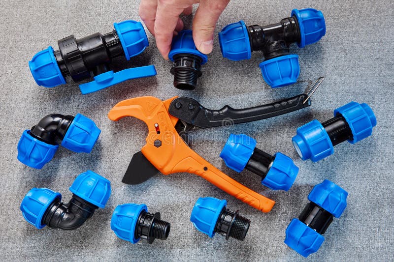 Hand of Plumber Choosing Compression Fitting for Connecting HDPE Pipes ...