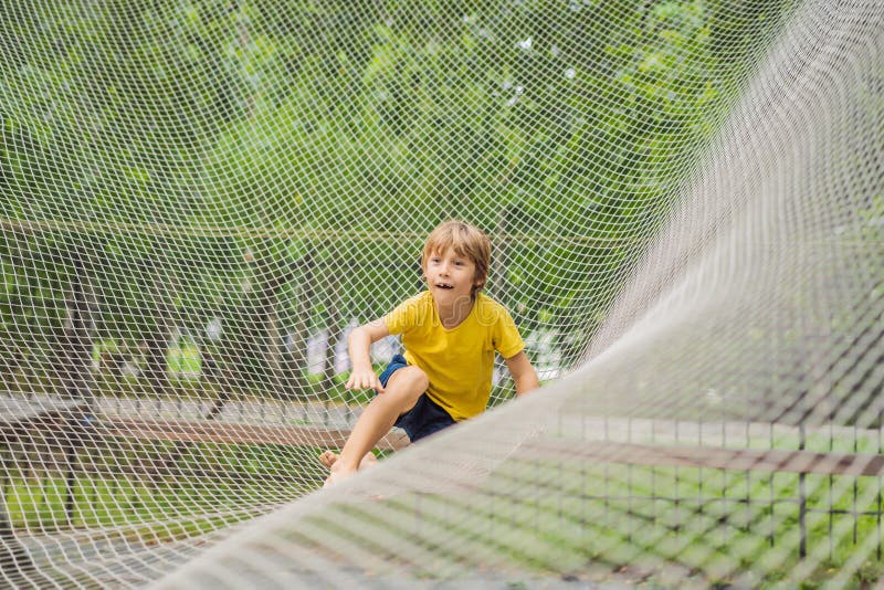 Practice Nets Playground. Boy Plays in the Playground Shielded with a ...