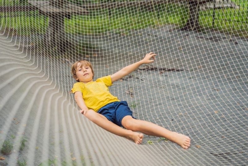 Practice Nets Playground. Boy Plays in the Playground Shielded with a ...