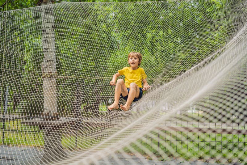 Practice Nets Playground. Boy Plays in the Playground Shielded with a ...