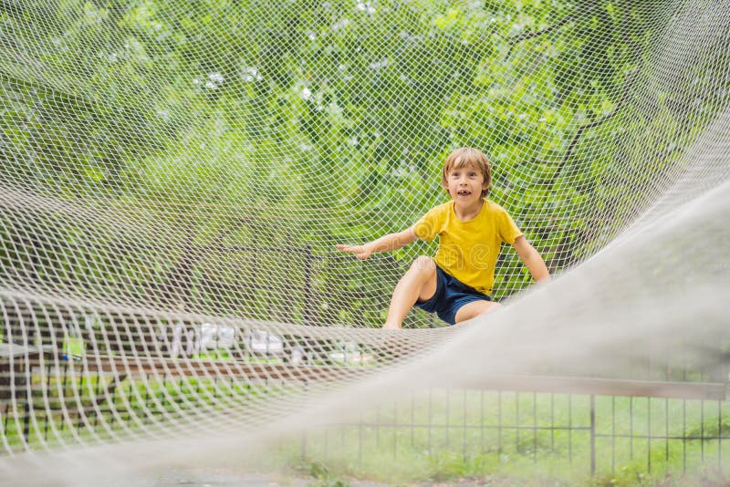 Practice Nets Playground. Boy Plays in the Playground Shielded with a ...