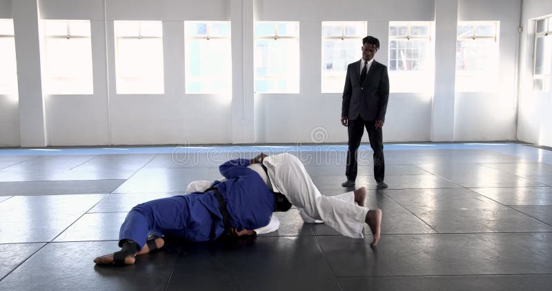Practicing Judo, Athletes Grappling on Mat in Martial Arts Uniforms ...