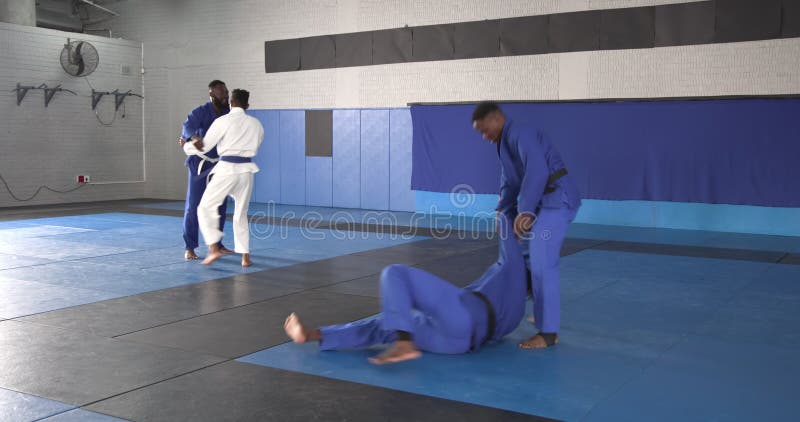 Practicing Judo, Athletes in Martial Arts Uniforms Training in Dojo ...