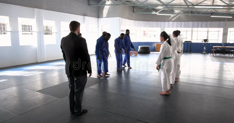 Celebrating Victory, Judo Team in White Uniforms Holding Trophy in Dojo ...