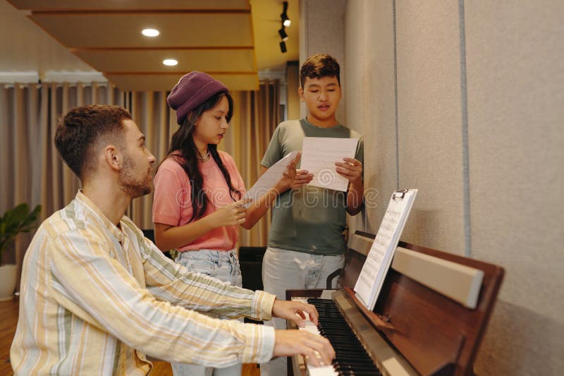 Practicing Music with Instructor at Piano Studio Stock Photo - Image of ...