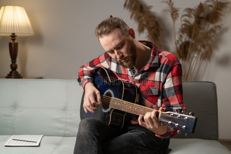 Practicing in Playing Guitar. Handsome Man Learning Playing Guitar at ...