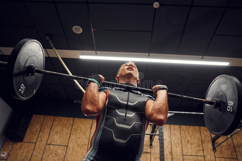 Practicing Process. Strong Man is Lifting Barbell in the Gym Stock ...