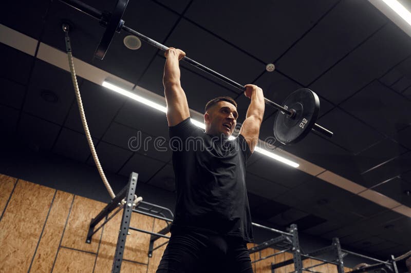 Practicing Process. Strong Man is Lifting Barbell in the Gym Stock ...