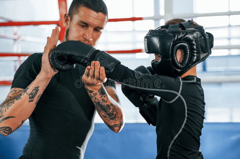 Practicing the Punches. Coach is Teaching the Boy Box Techniques ...