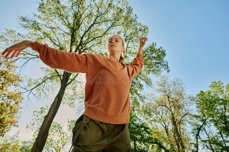 Practicing Yoga Outdoors among Trees in Forest Setting Stock Photo ...