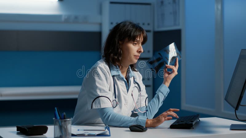 Practitioner Holding Radiography Analyzing Lungs before Writing Medical ...