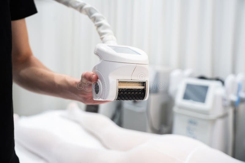 Hands Holding a Modern Body Contouring Device in a Wellness Center ...