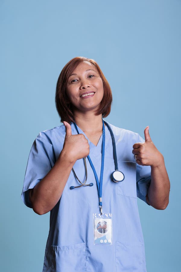 Practitioner Nurse with Medical Stethoscope Smiling at Camera while ...