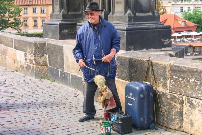 PRAGUE, CZECH - JULY 30, 2007 - an Old Puppet Master with a Puppet ...