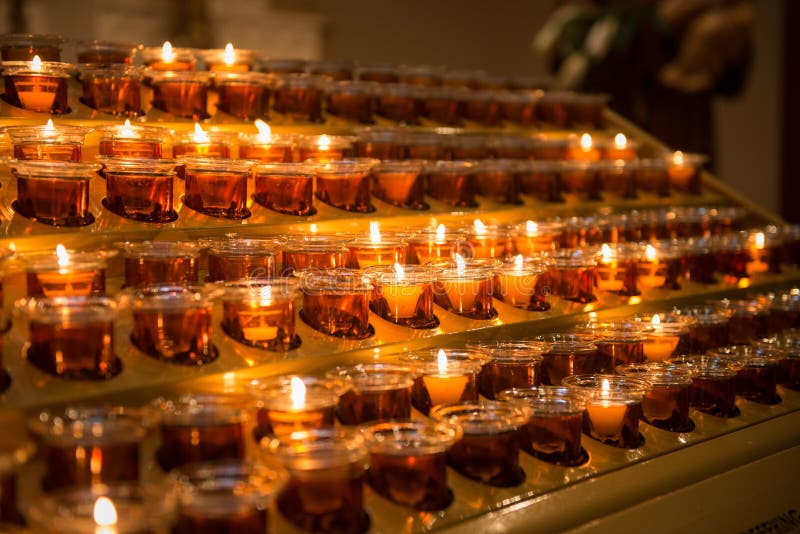 Prayer Candles Light Up the Darkness in a Church Stock Photo - Image of ...