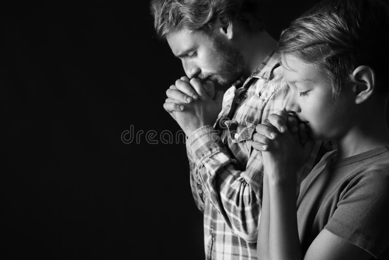 Praying Father and Son on Dark Background Stock Photo - Image of ...