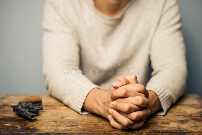 Praying man with a gun stock photo. Image of firearm - 32990852
