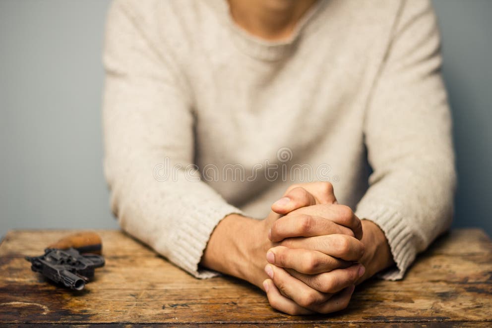 Praying man with a gun stock photo. Image of firearm - 32990852