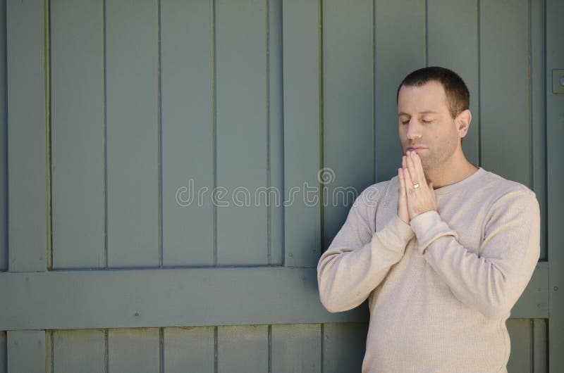 Man Standing and Praying on a Hillside. Stock Image - Image of young ...