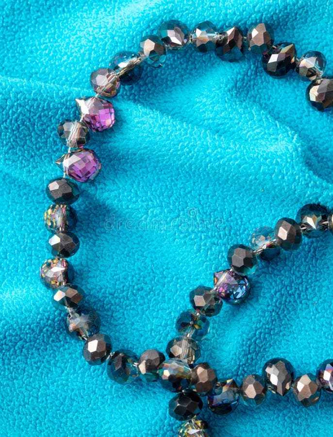 Precious Stones on Beads on Blue Fabric. Background Stock Image - Image ...