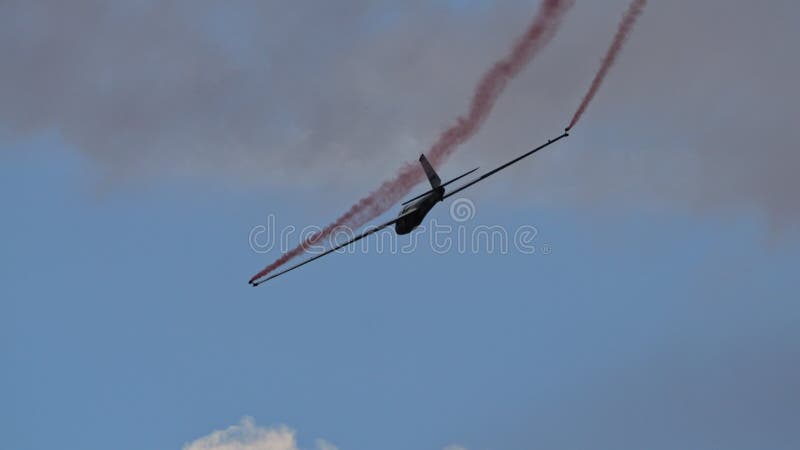 Precision in Flight Glider Performing a Four-Point Roll with Wingtip ...