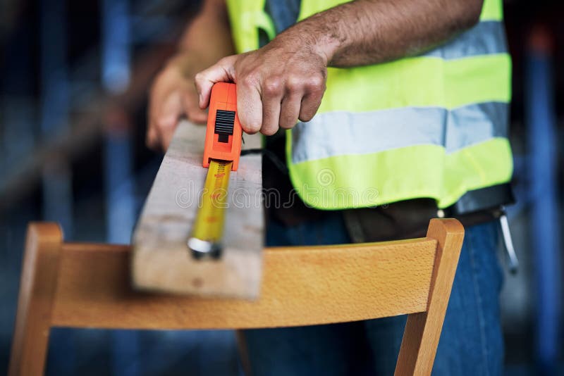 Precision is Perfection. a Builder Using a Measuring Tape at a ...