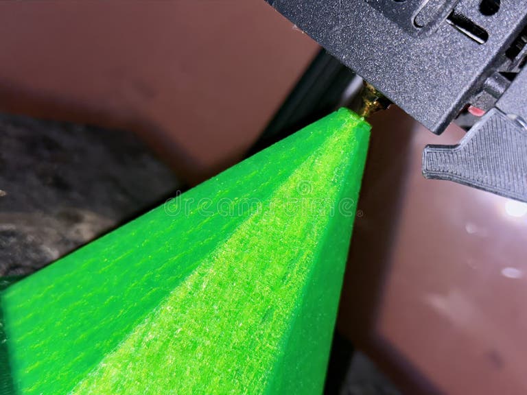 Precision in Progress: Close-Up of a 3D Printer Creating a Bright Green ...
