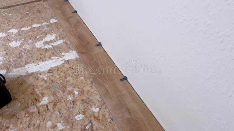 Precision in Progress: Installing a Vinyl Floorboard Stock Footage ...