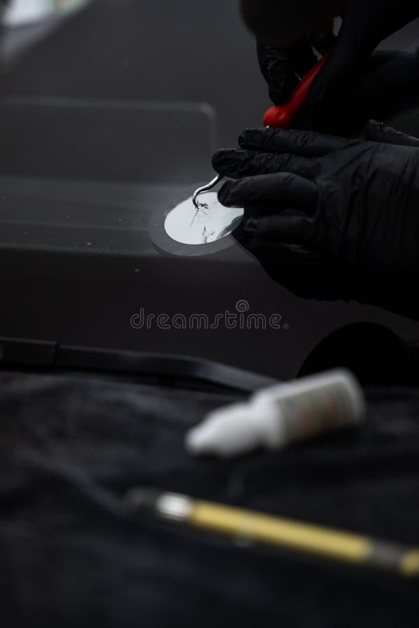 Precision Windshield Crack Repair in Progress with Specialized Tools ...