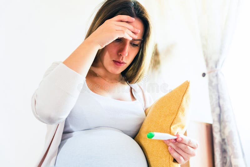 Pregnancy Fever Temperature Check. Pregnant Woman Holding Thermometer ... Pregnancy Fever Temperature Check. Pregnant Woman Holding Thermometer ...