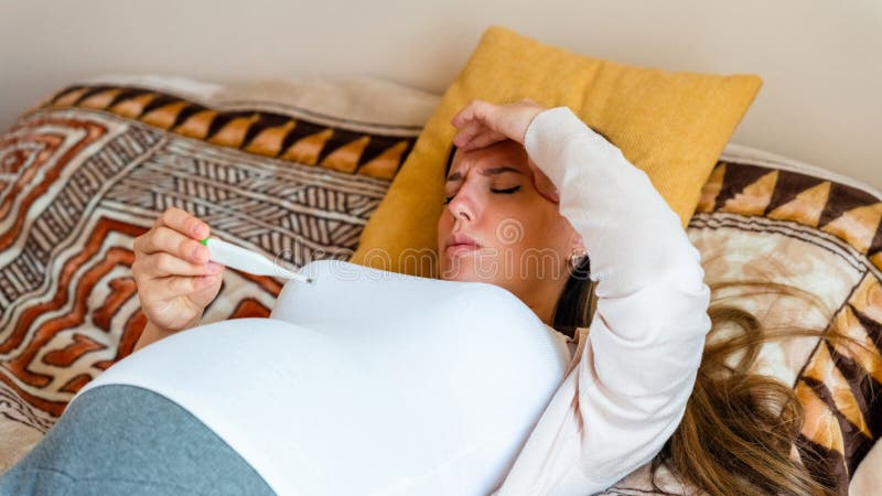 Pregnancy Fever Temperature Check. Pregnant Woman Holding Thermometer ... Pregnancy Fever Temperature Check. Pregnant Woman Holding Thermometer ...